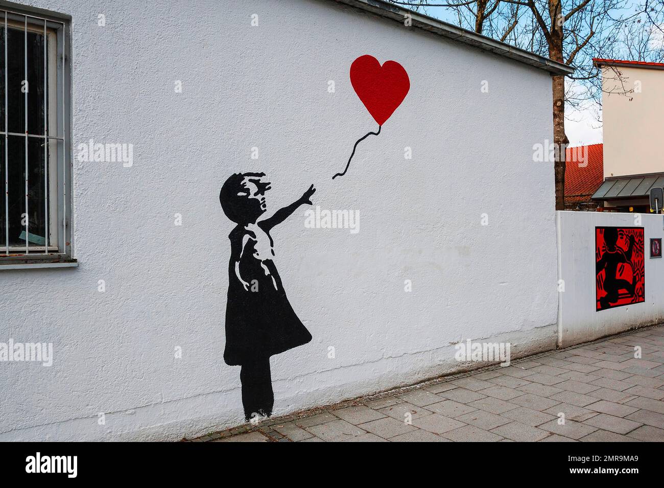 Wall with graffiti, remake of famous Bansky work, girl with balloon ...