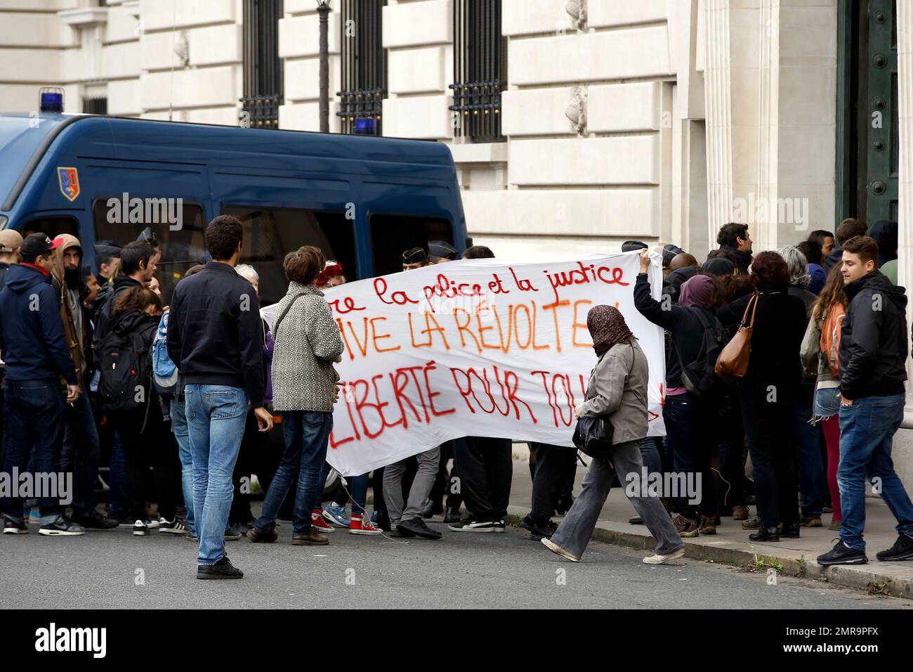 Youths carry a banner reading "Against police and justice, long live ...