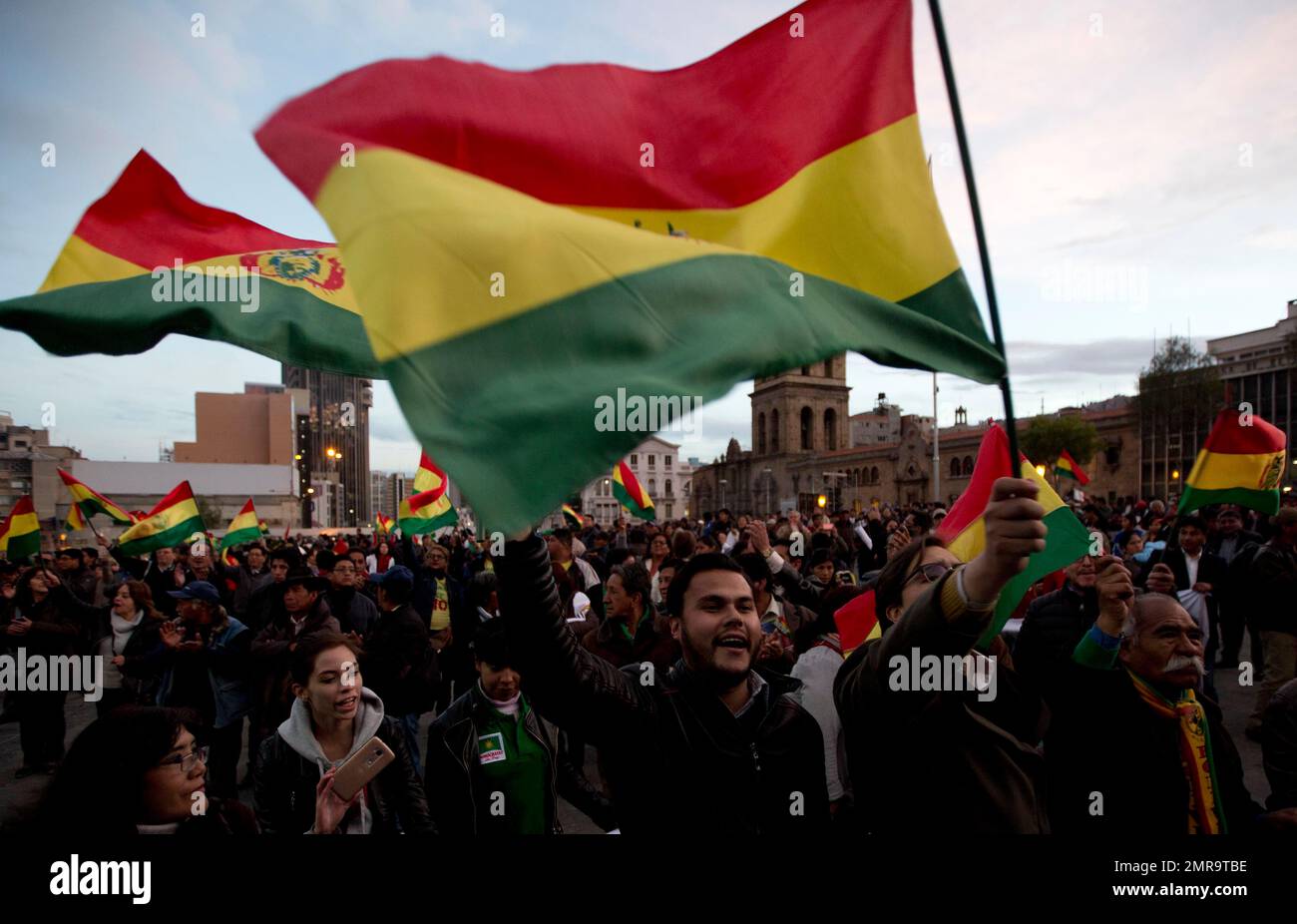People shout anti-government slogans and wave Bolivian flags as they ...