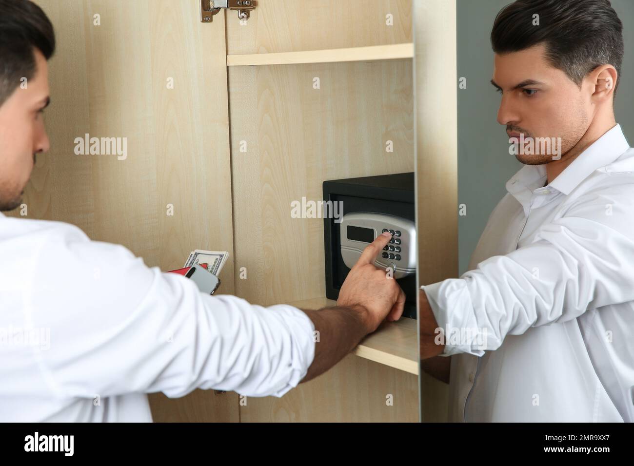 Man opening black steel safe with electronic lock at hotel Stock Photo ...