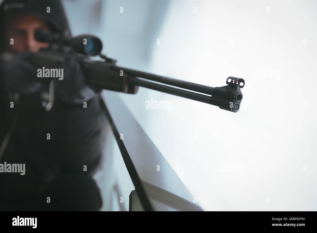 Hired professional killer indoors, focus on sniper rifle Stock Photo ...