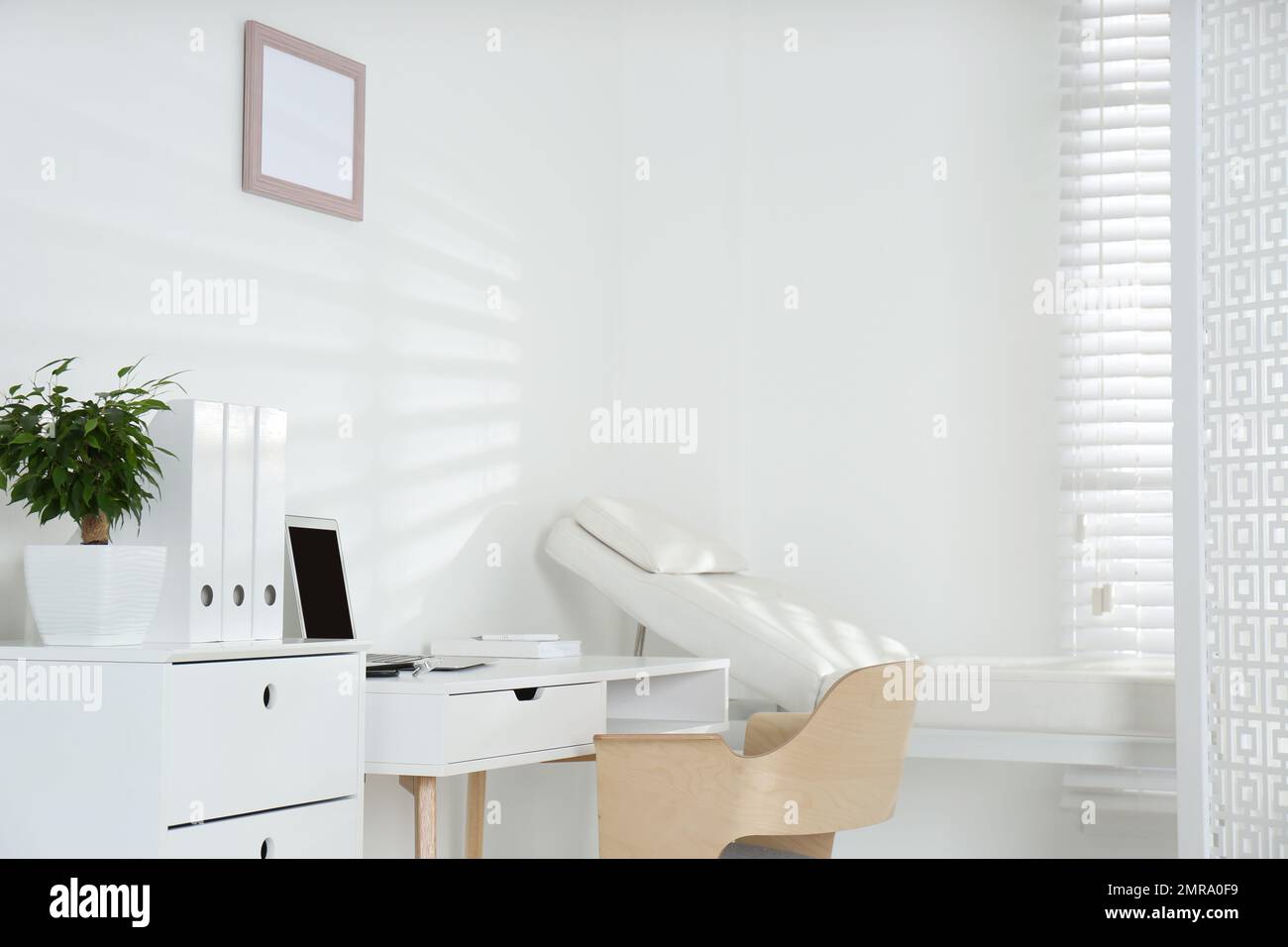 Doctor's office interior with examination couch and desk Stock Photo ...