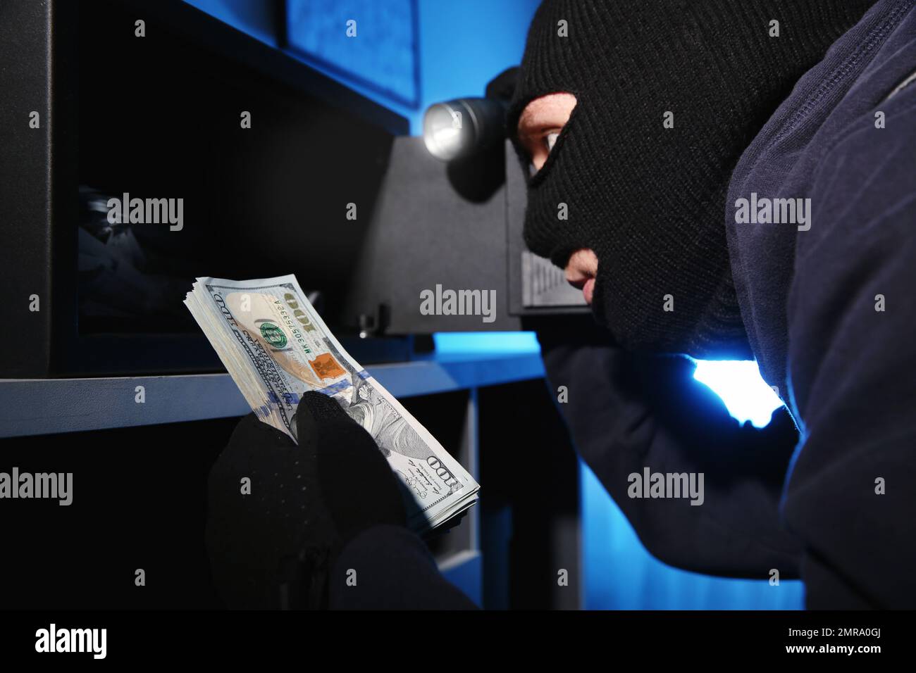 Thief taking money out of steel safe indoors at night, closeup Stock ...
