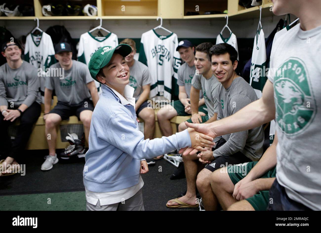 Coleman Walsh, 10, of Walpole, Mass., center, greets members of the ...