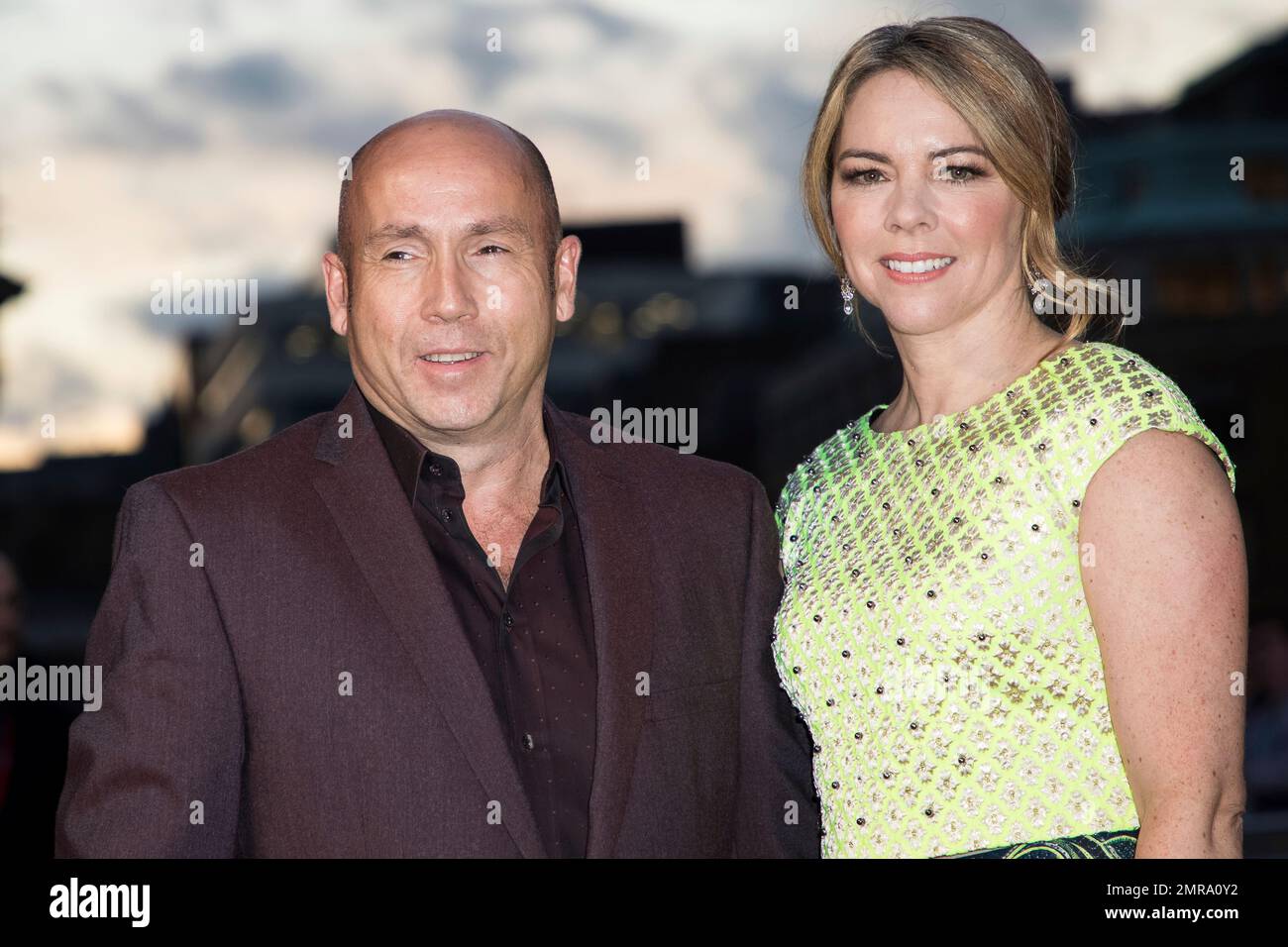 Producer J. Miles Dale, left poses with a guest for photographers upon ...