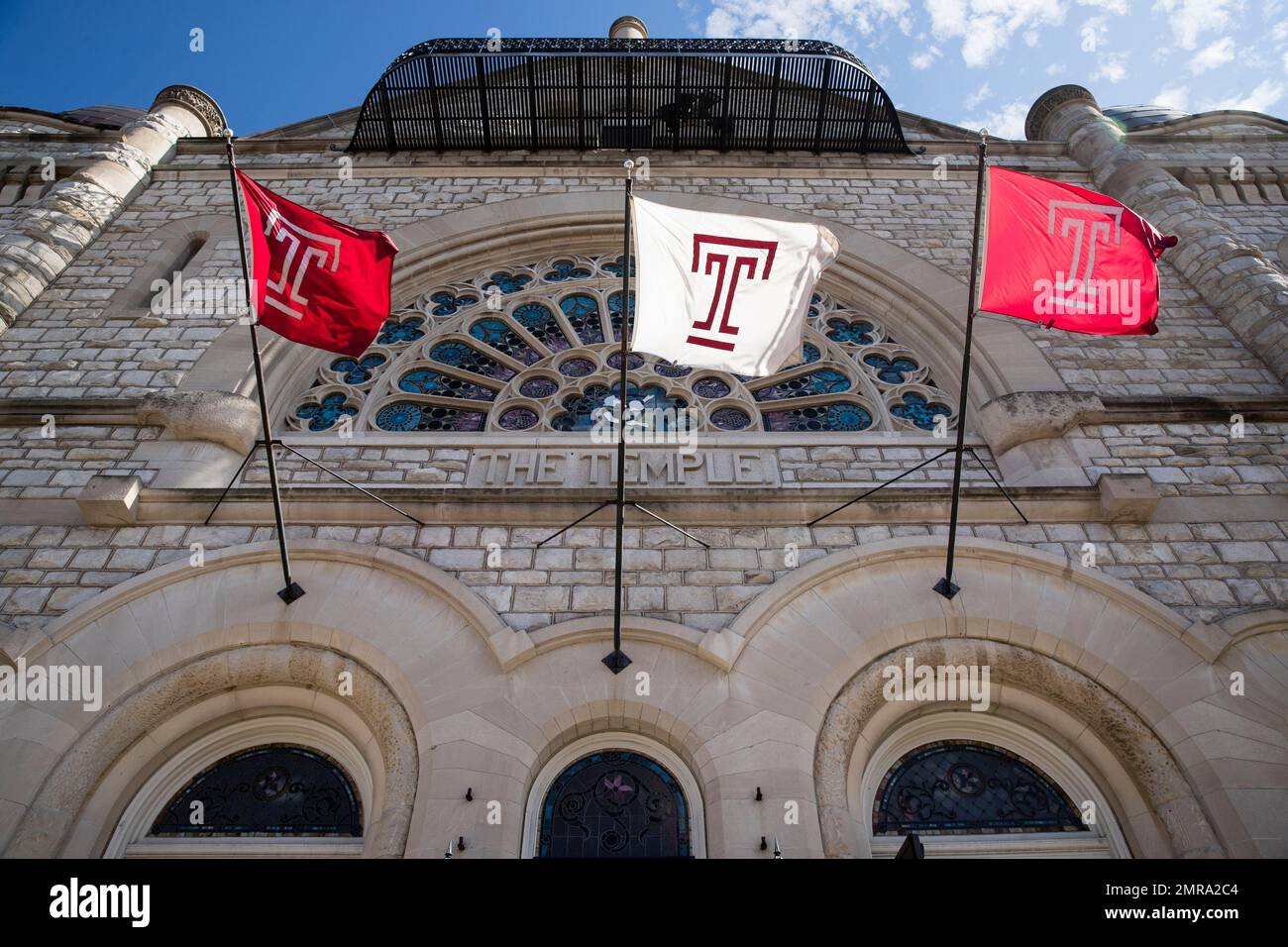 Flags wave in the wind from a building on the at Temple University ...