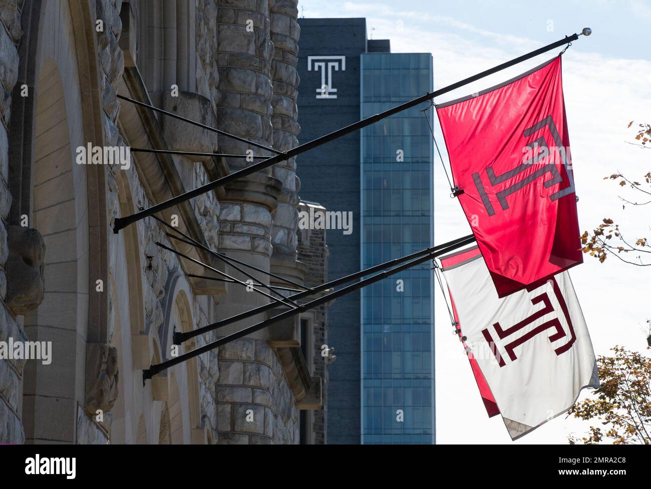 Flags wave in the wind from a building on the at Temple University ...