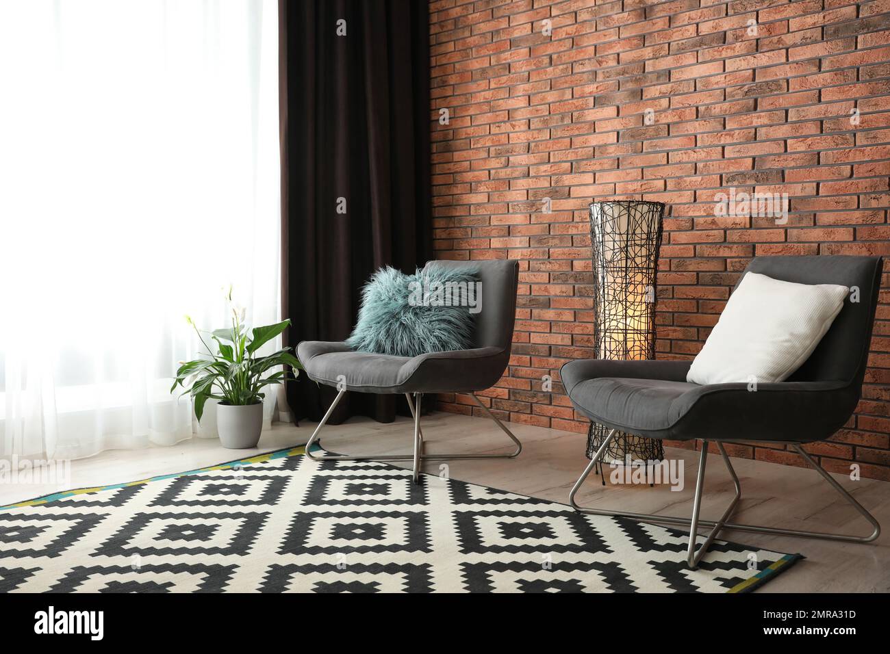 Comfortable chairs near window with elegant curtains in room Stock ...