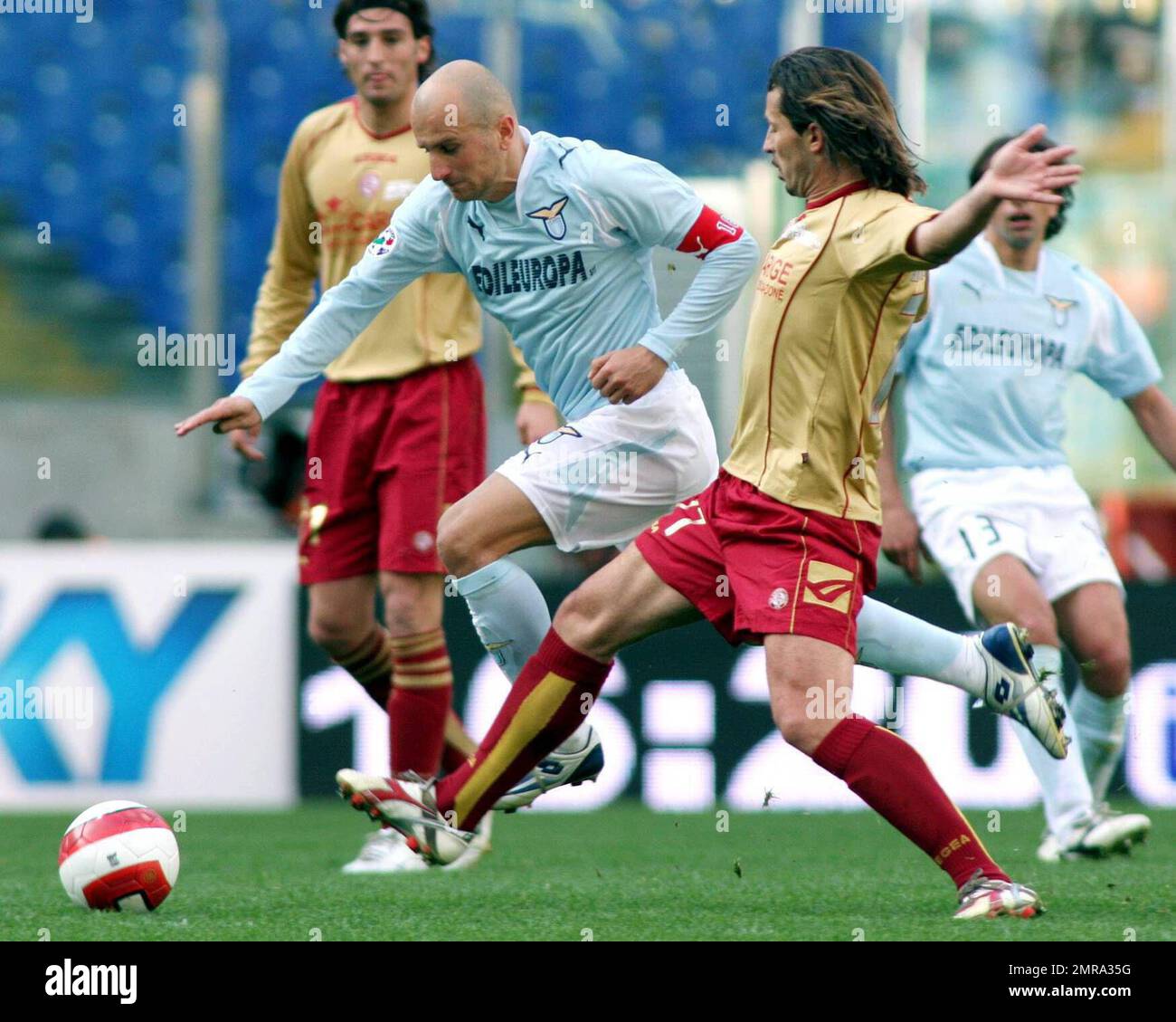 Tommso Rocchi fights a ball with Livorno's players Grandoni in the ...