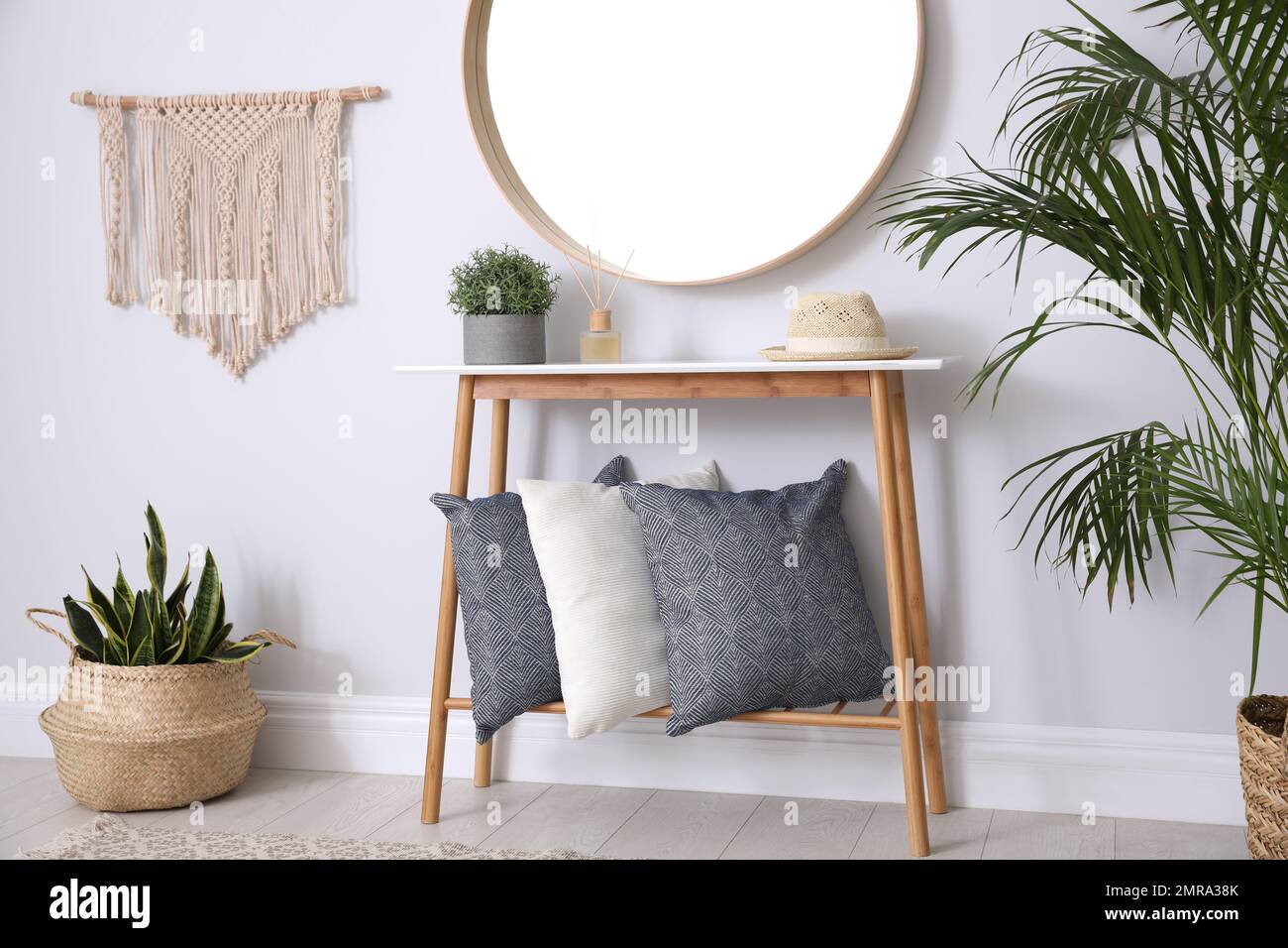 Round mirror and wooden table at home. Idea for interior design Stock ...