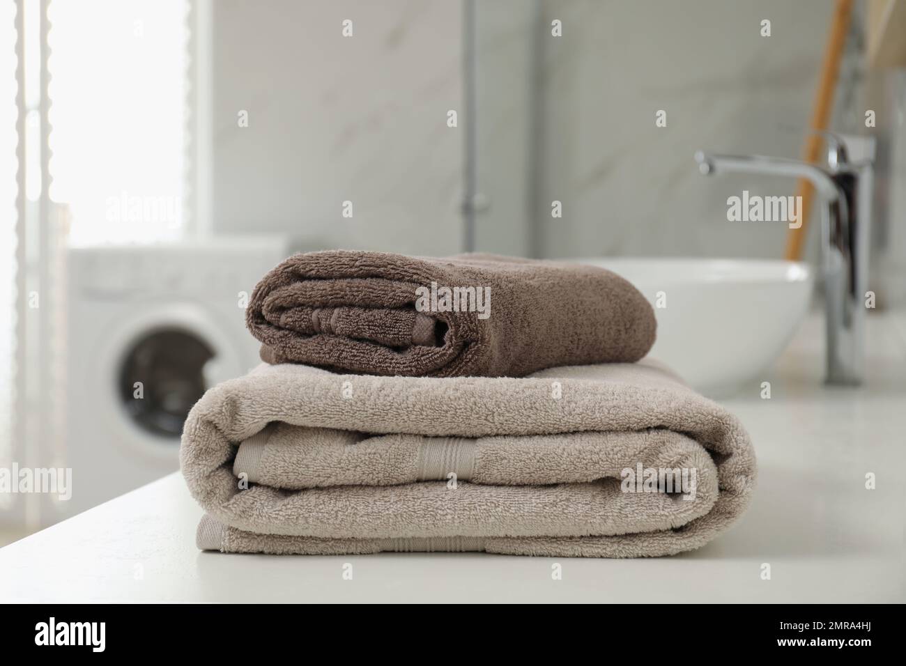 Stack of clean towels on bathroom countertop Stock Photo - Alamy