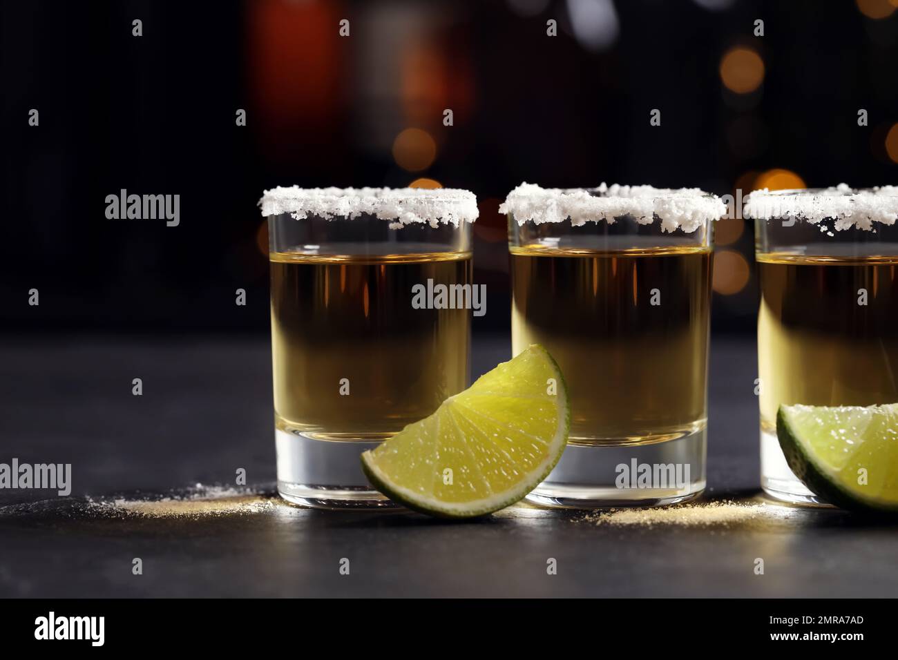 Mexican Tequila shots, lime slices and salt on bar counter Stock Photo ...