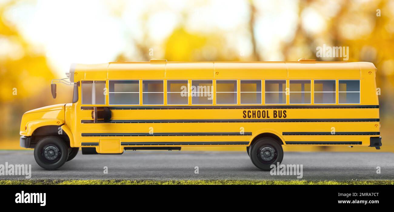 Yellow school bus on road outdoors. Transport for students Stock Photo ...