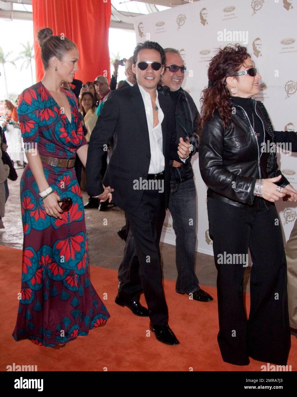 Jennifer Lopez and husband Marc Anthony walk the orange carpet with ...