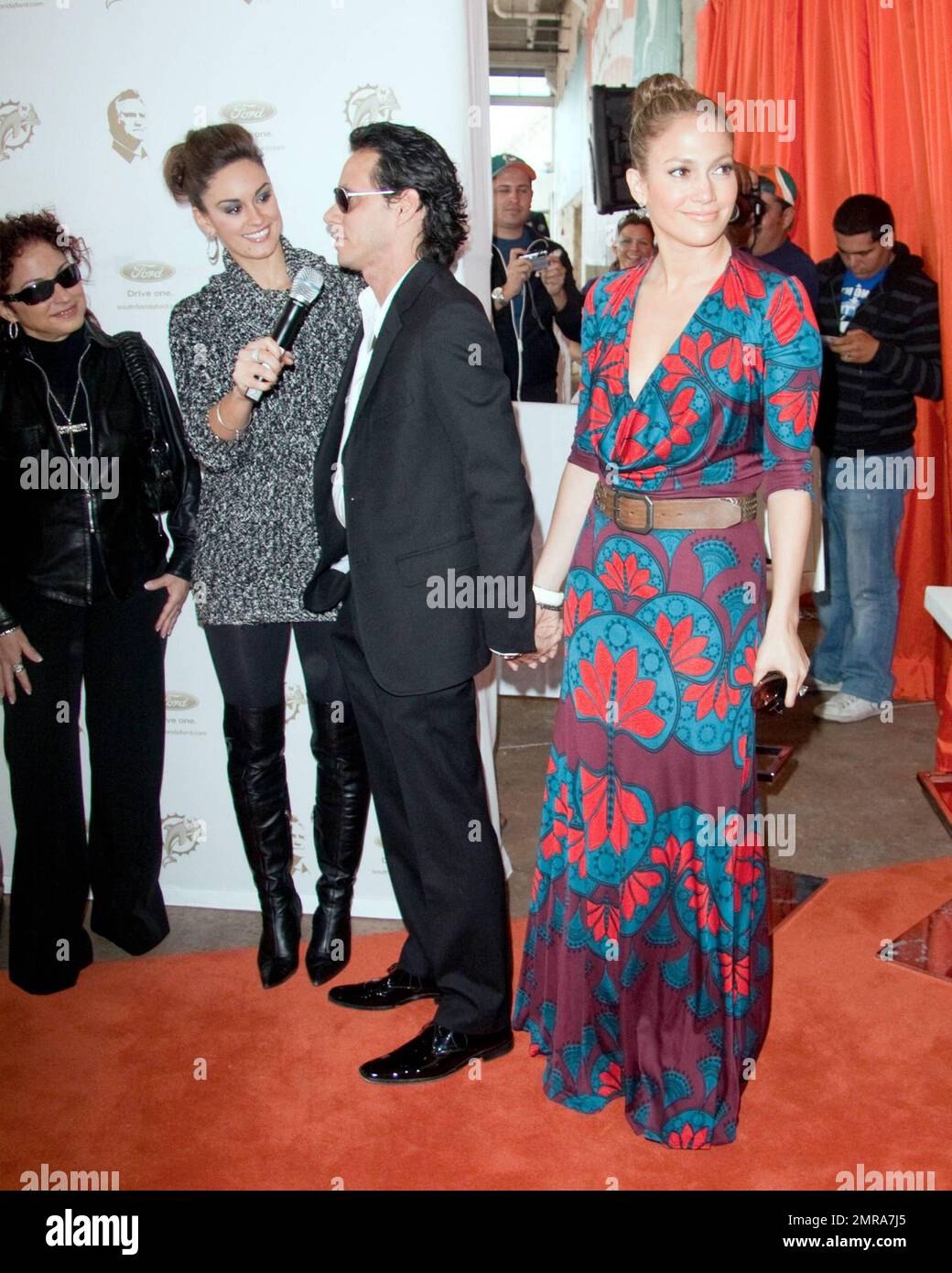 Jennifer Lopez and husband Marc Anthony walk the orange carpet with ...