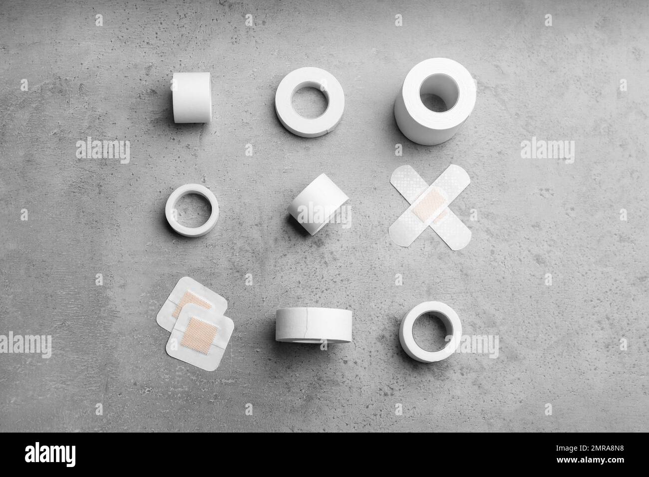 Different types of sticking plasters on stone background, flat lay ...