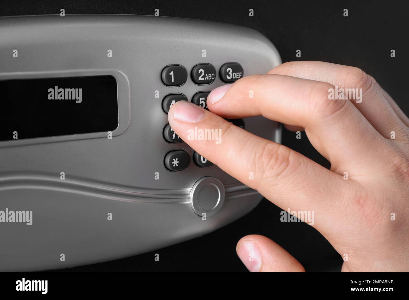 Man opening black steel safe with electronic lock, closeup Stock Photo ...