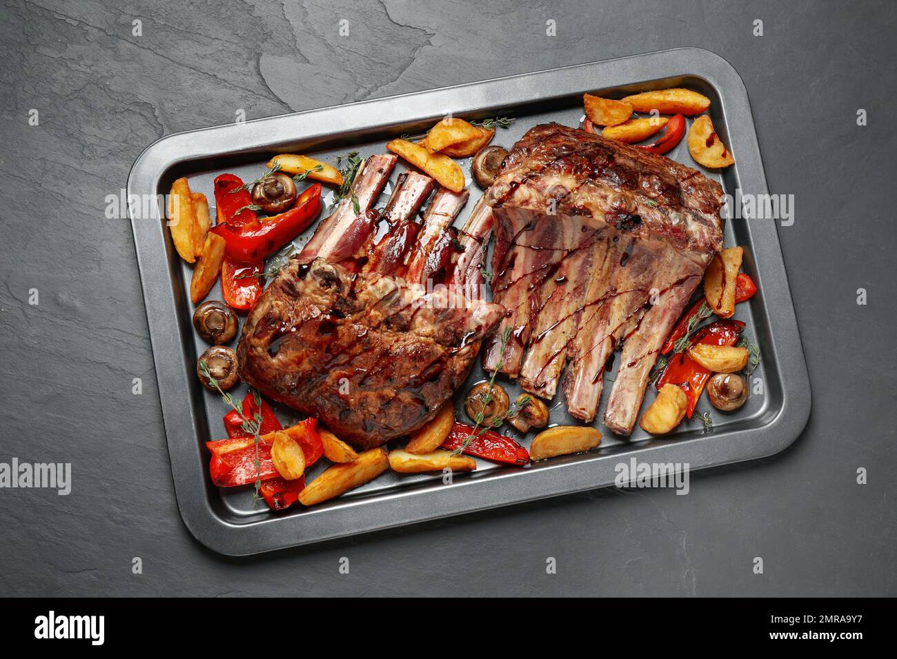 Delicious roasted ribs with garnish, top view Stock Photo - Alamy