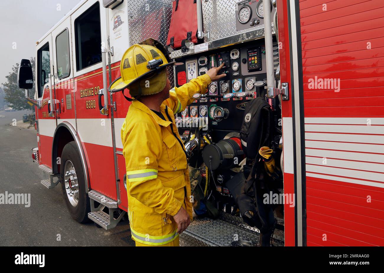 A fireman checks gauges on a fire truck on Monday, Oct. 9, 2017, in ...