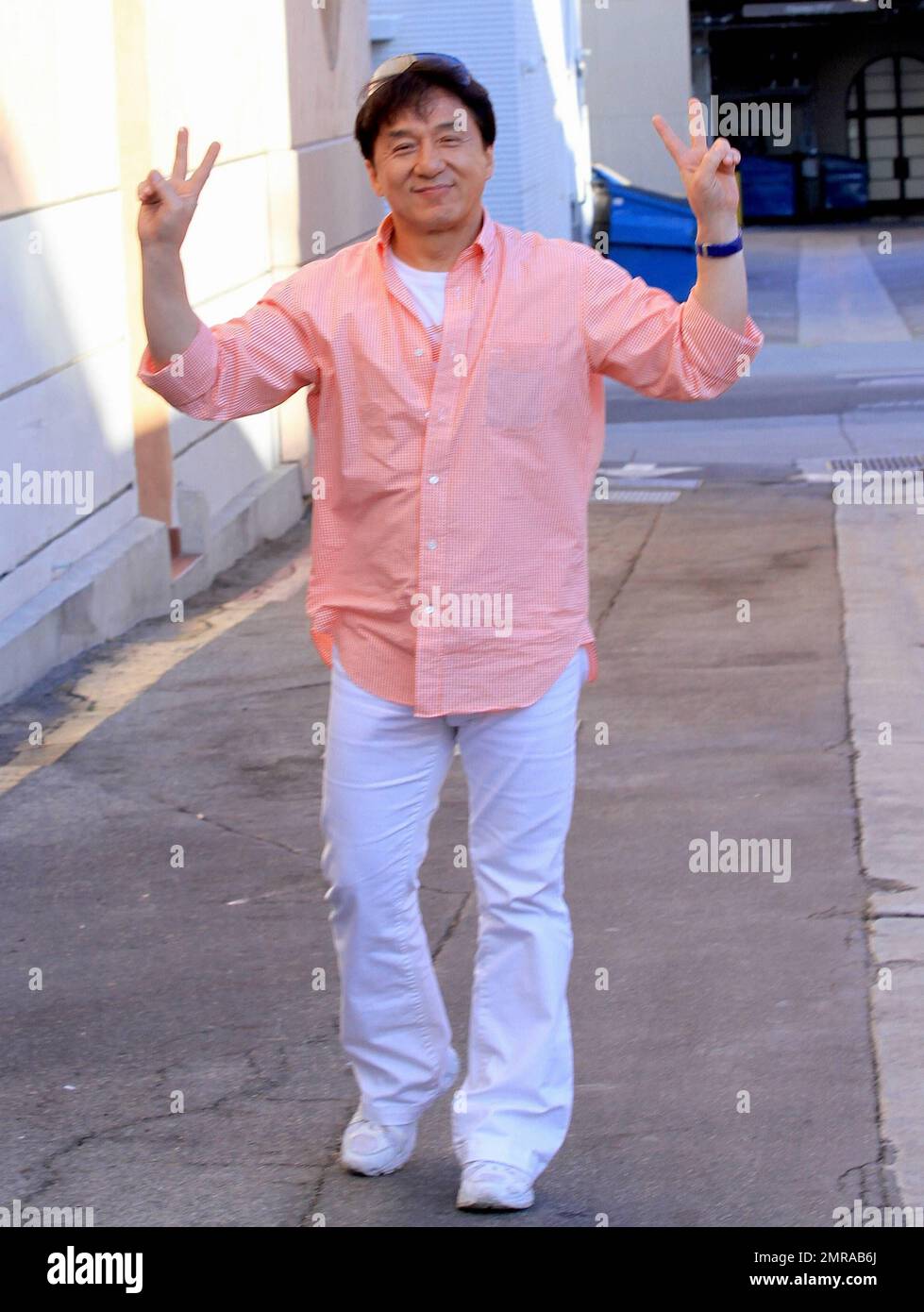 EXCLUSIVE!! Actor Jackie Chan flashes a peace sign and smiles while out ...