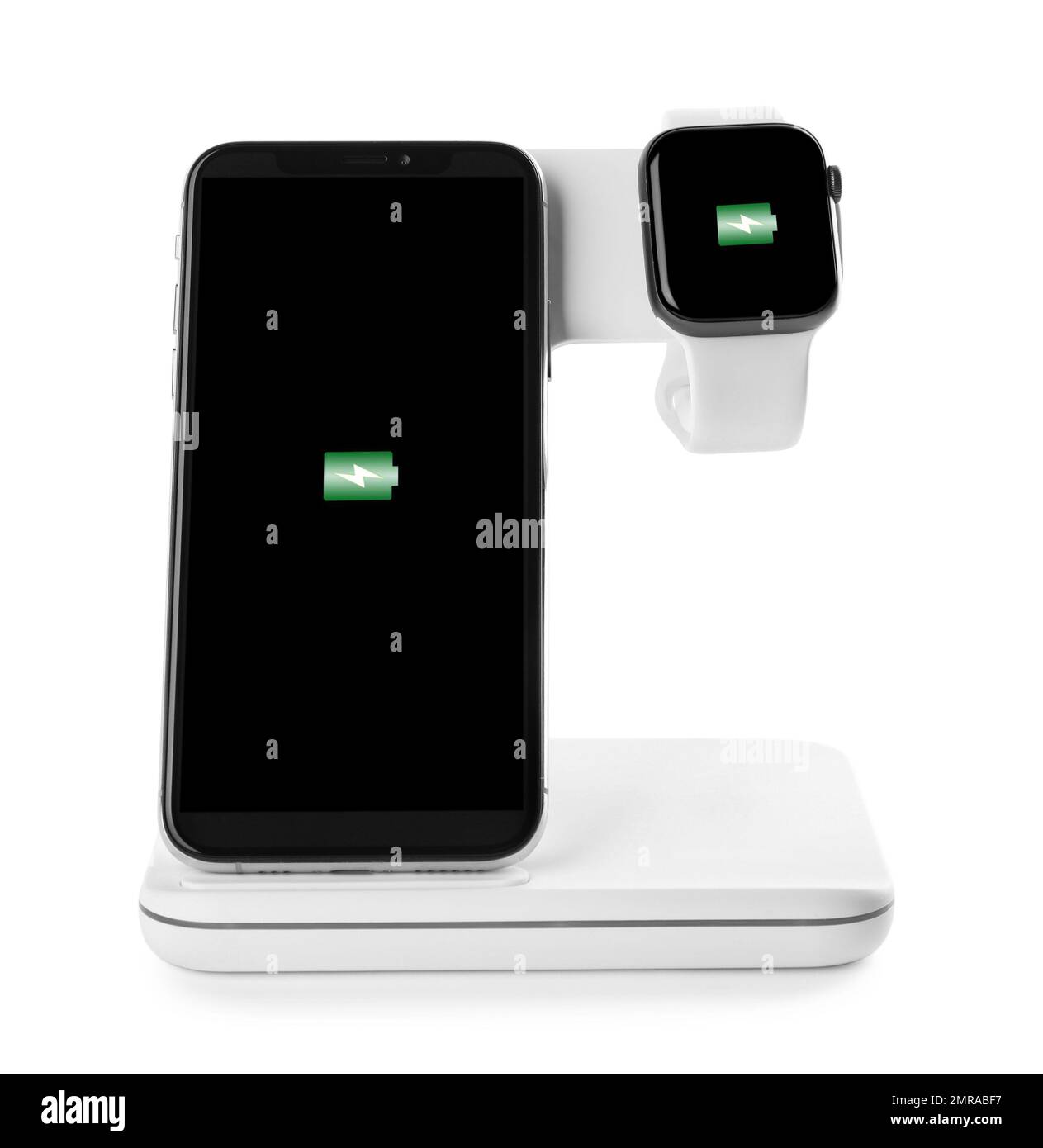 Mobile phone and smartwatch charging with wireless pad isolated on ...
