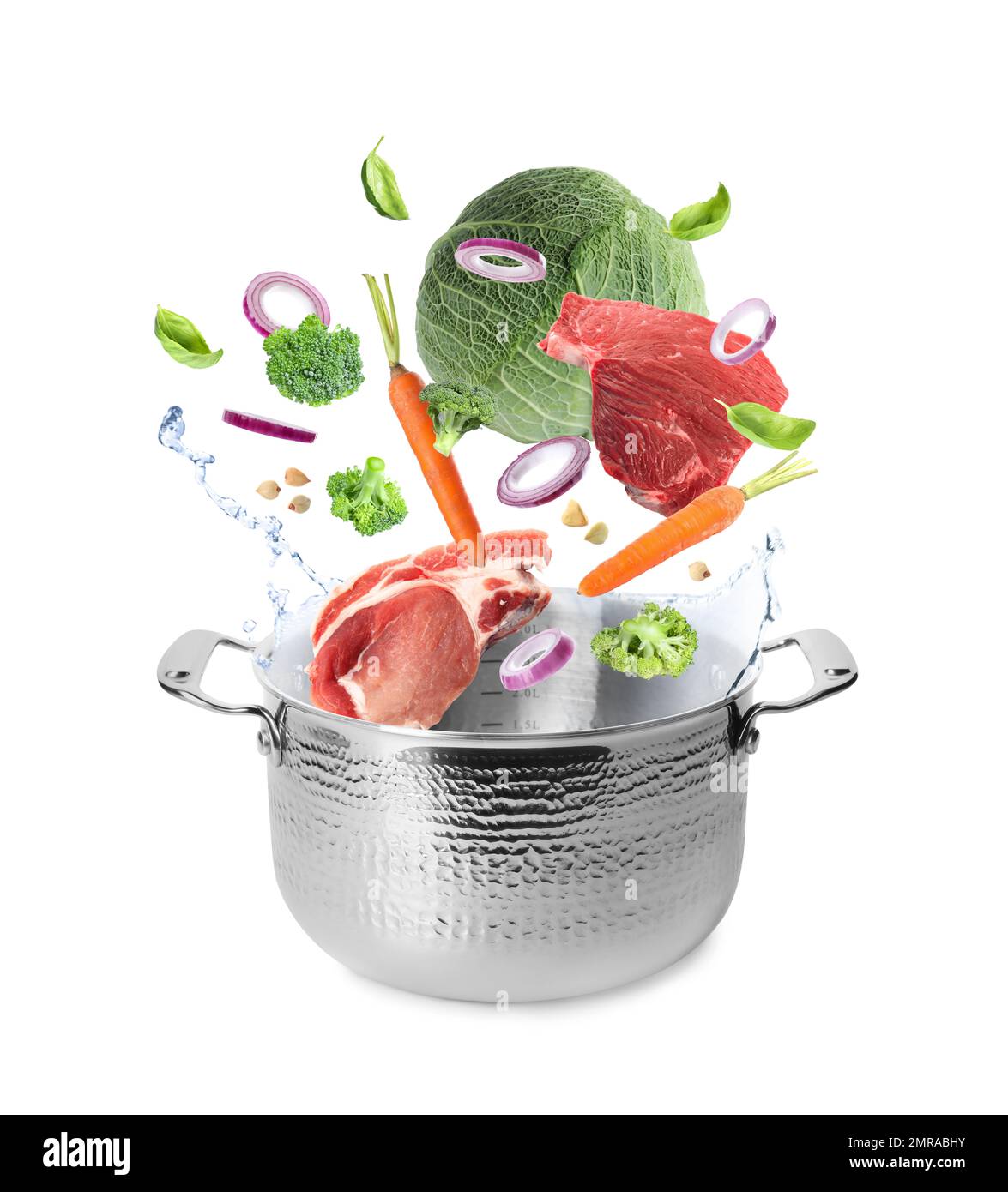 Many different ingredients falling into pot on white background ...