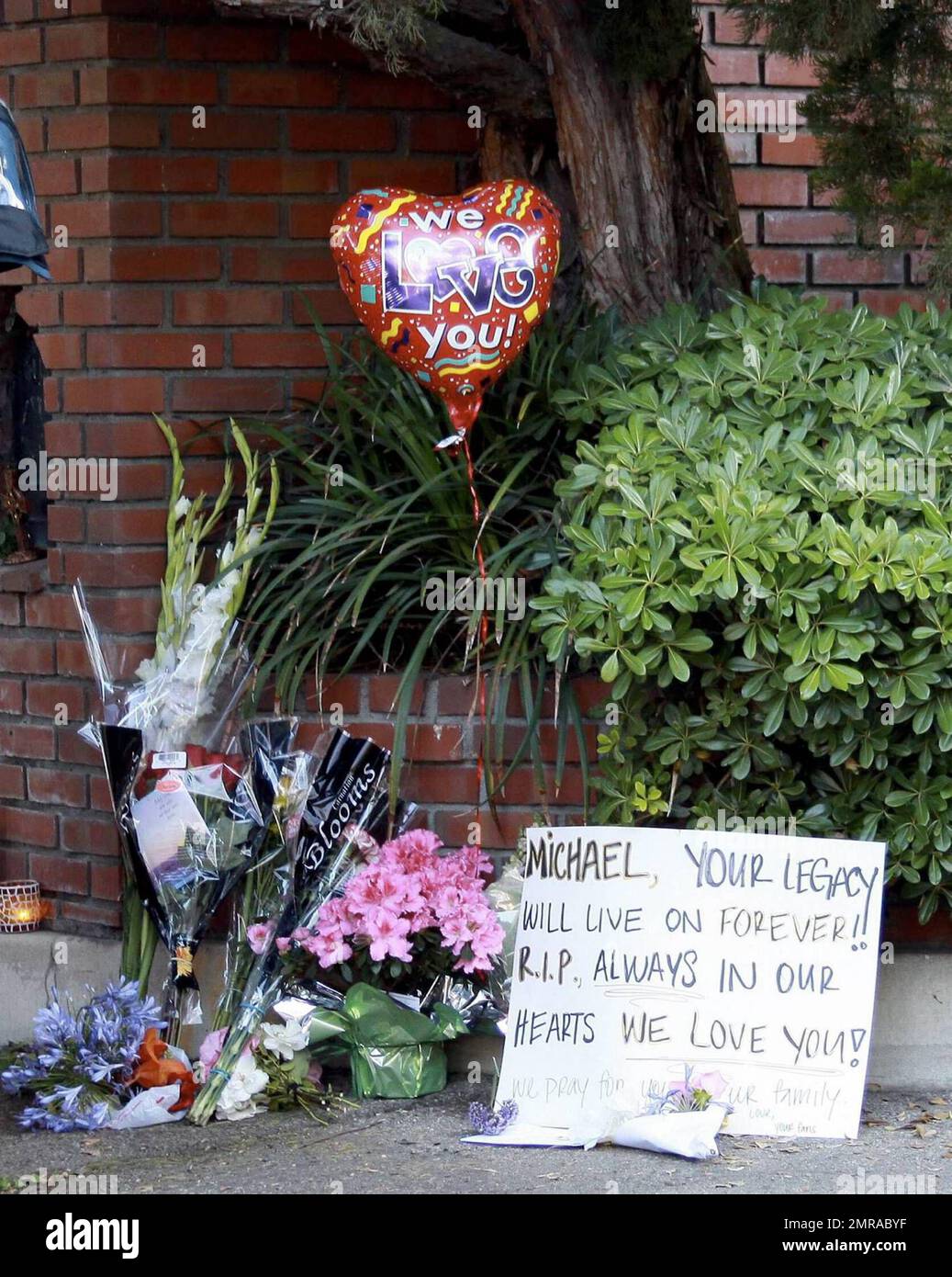 Fans and friends gather outside the Jackson family compound to leave ...