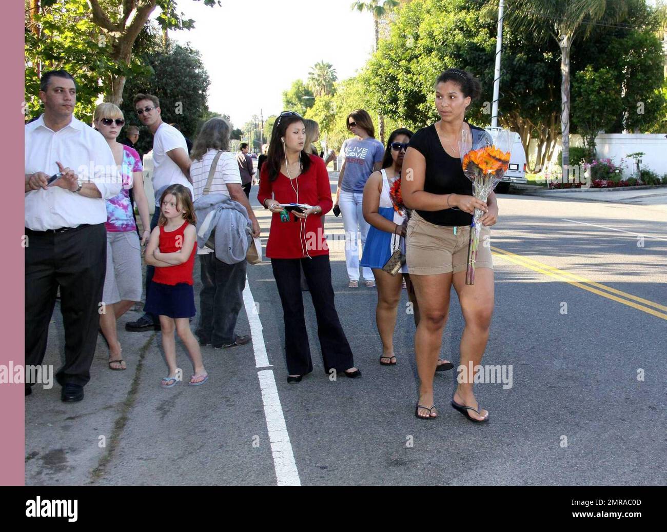 Fans and friends gather outside the Jackson family compound to leave ...