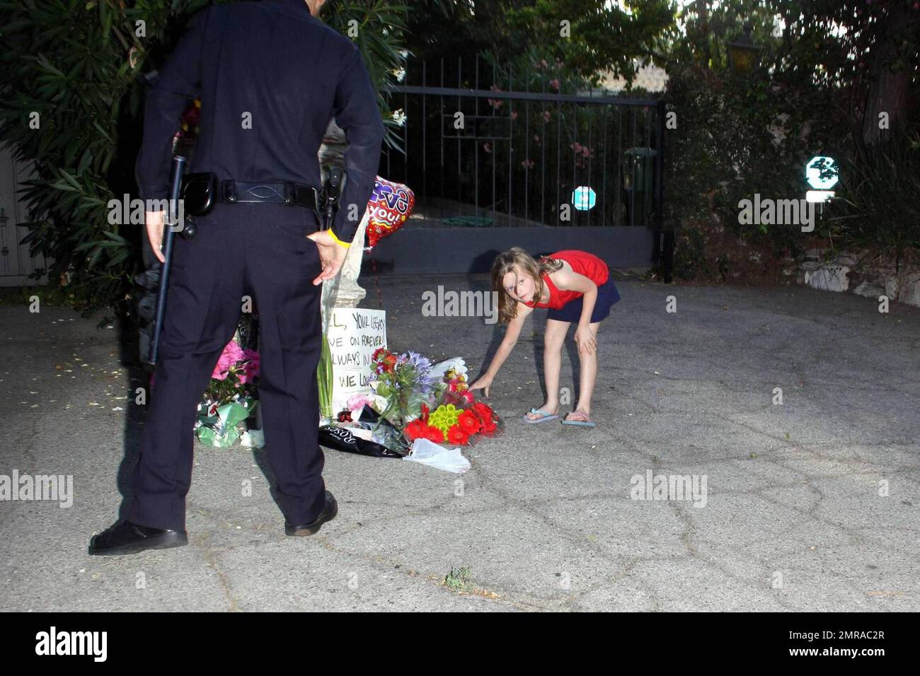 Fans and friends gather outside the Jackson family compound to leave ...