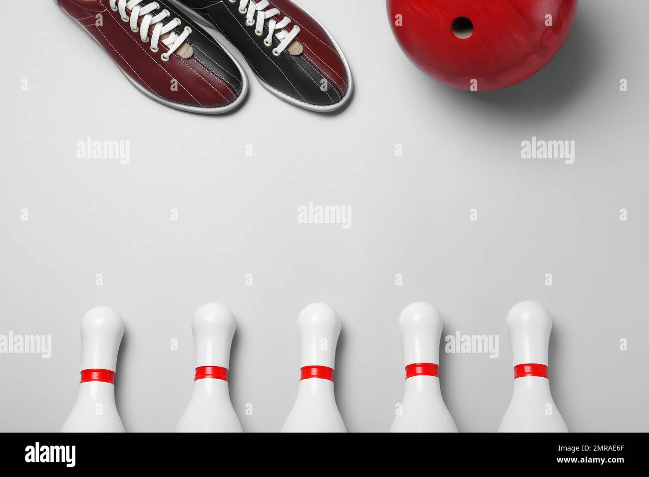 Bowling ball, shoes and pins on white background, flat lay Stock Photo ...