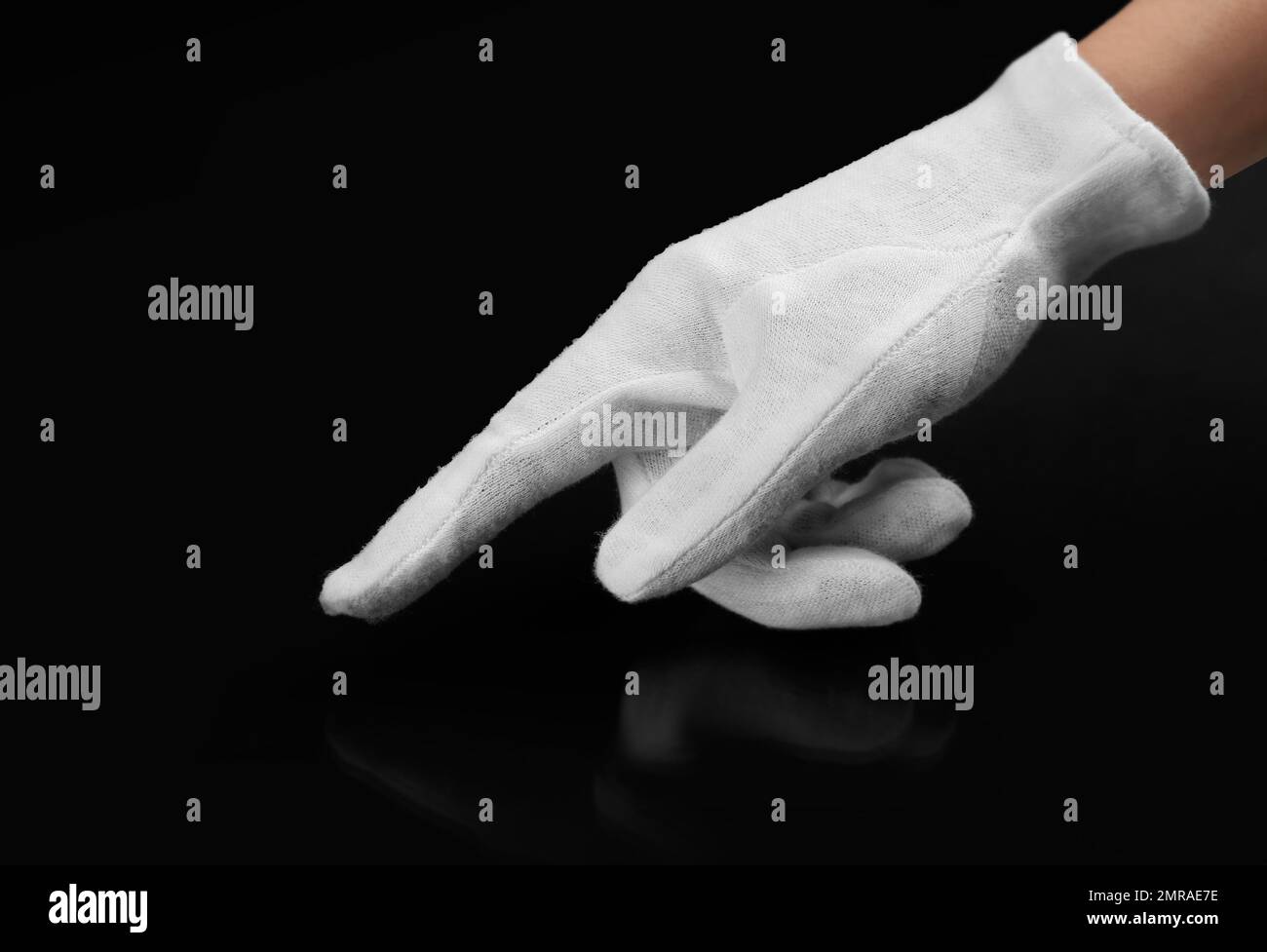 Person in white glove checking cleanliness of black background, closeup ...