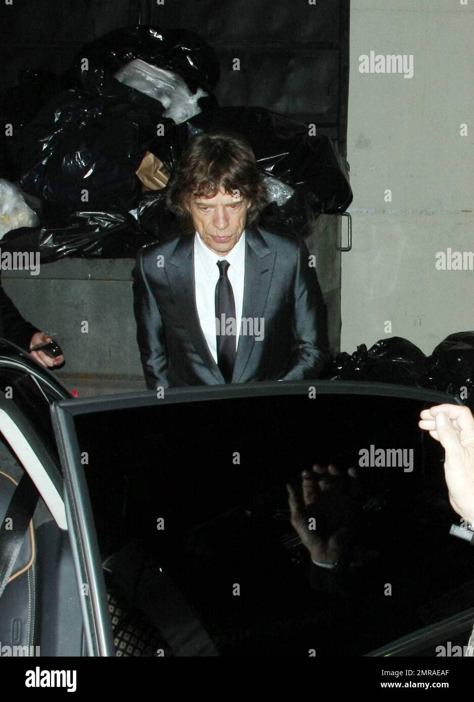 Exclusive!! Mick Jagger gets taken out with the trash! Jagger was ...