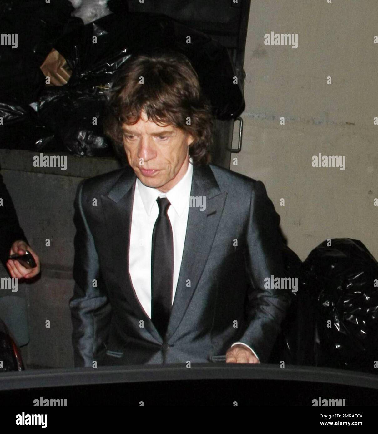 Exclusive!! Mick Jagger gets taken out with the trash! Jagger was ...