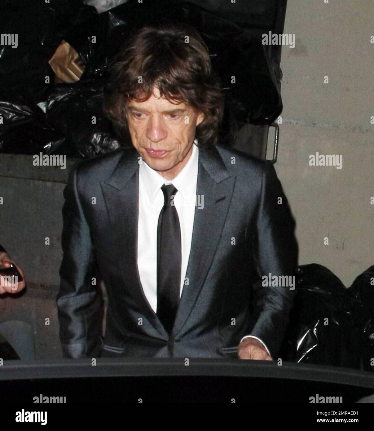 Exclusive!! Mick Jagger gets taken out with the trash! Jagger was ...