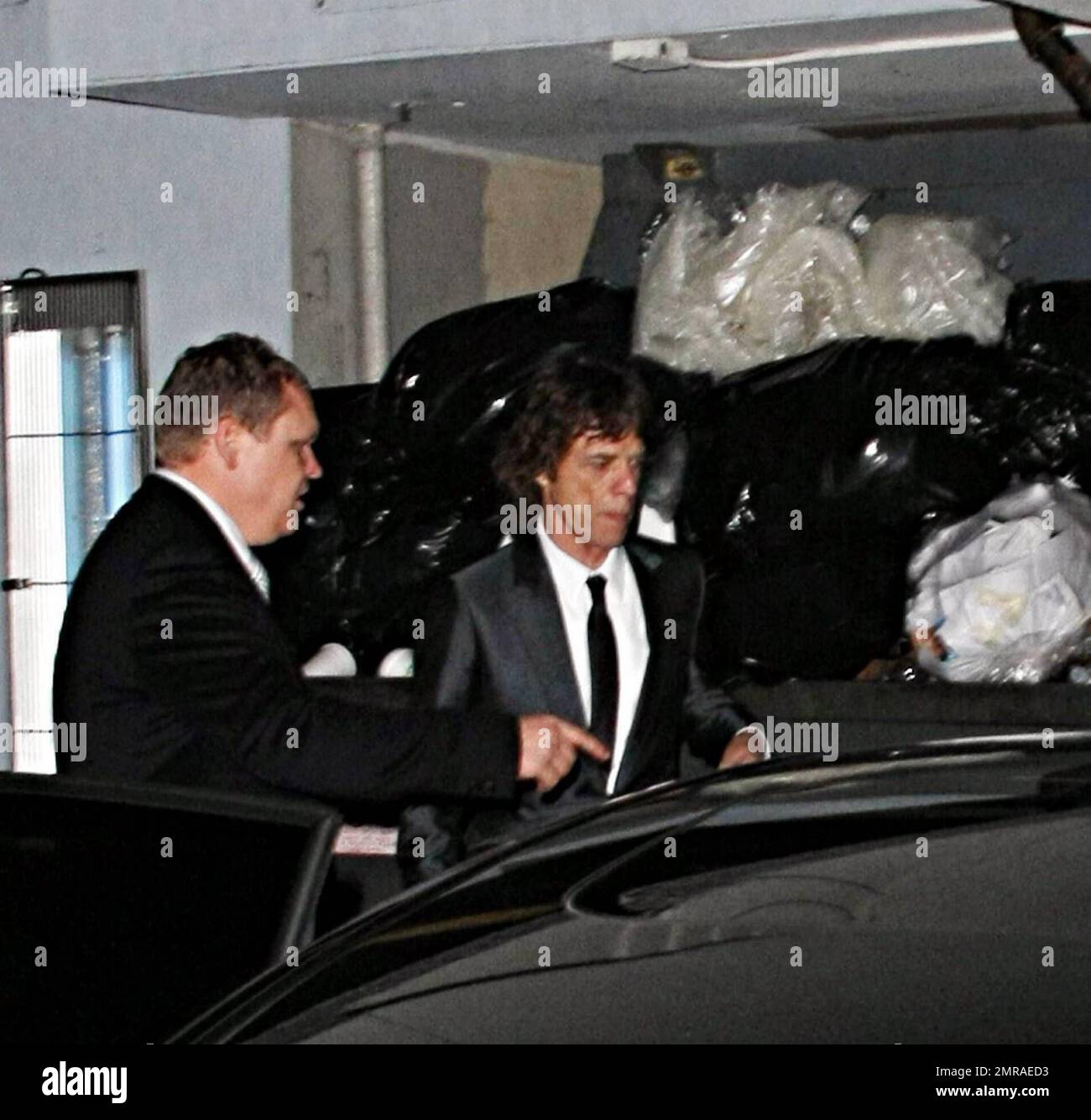 Exclusive!! Mick Jagger gets taken out with the trash! Jagger was ...