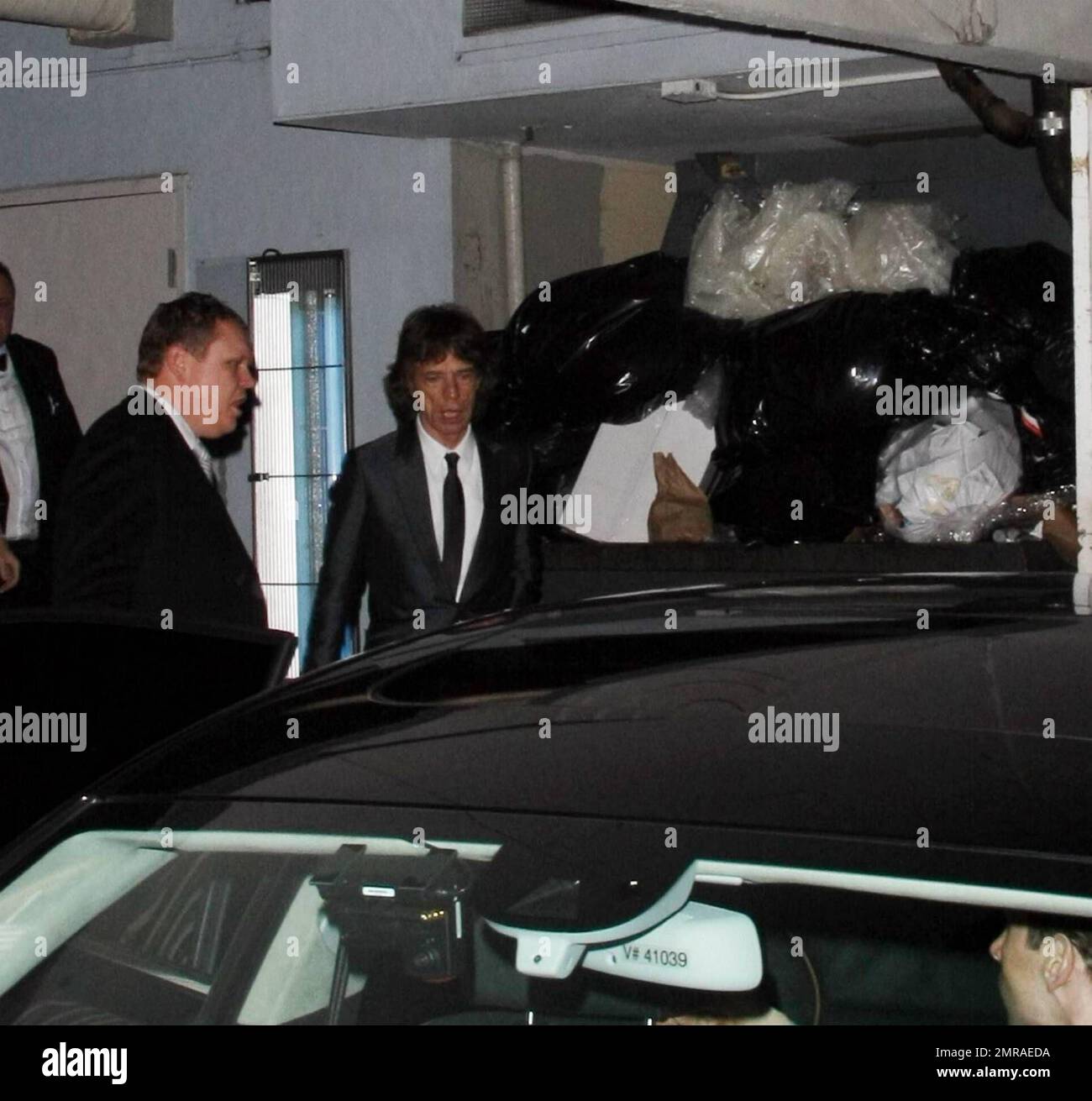 Exclusive!! Mick Jagger gets taken out with the trash! Jagger was ...