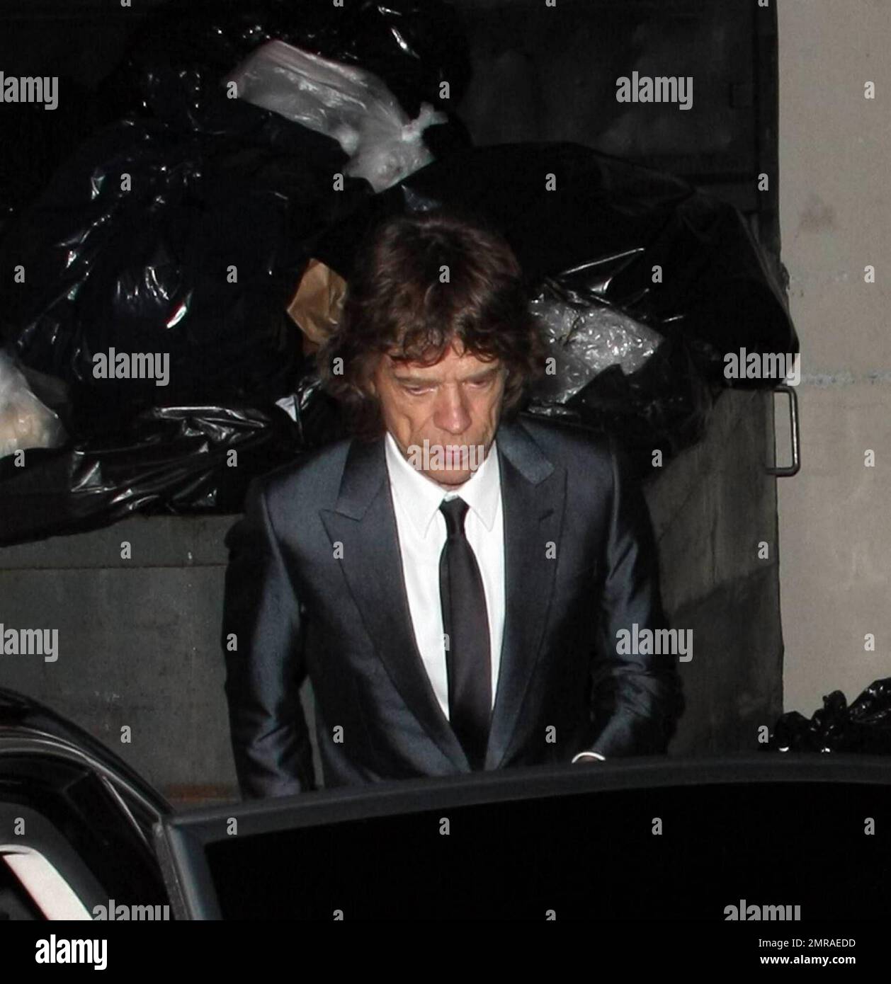 Exclusive!! Mick Jagger gets taken out with the trash! Jagger was ...
