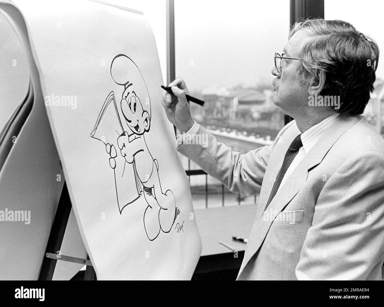 Pierre "Peyo" Culliford, 55, of Brussels, Belgium, sketches one of the ...