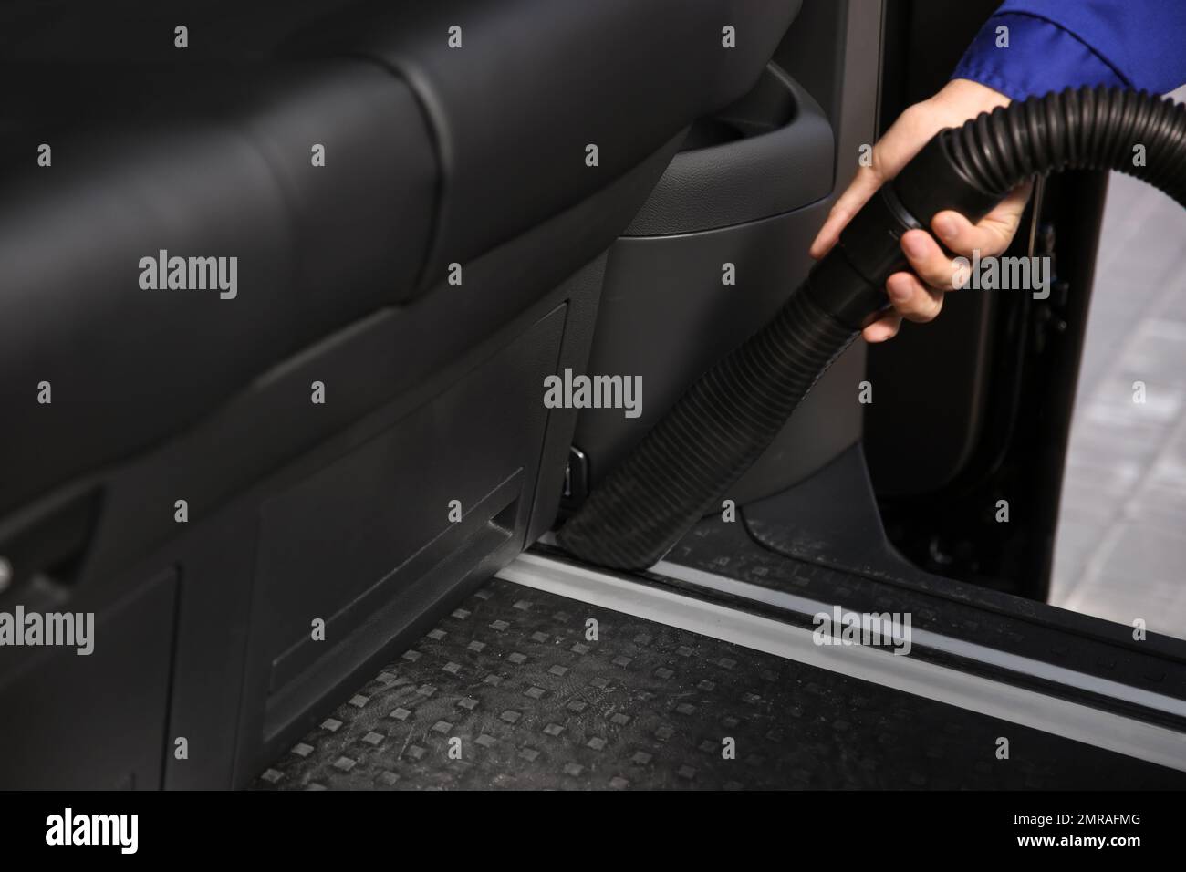 Car wash worker vacuuming modern automobile, closeup Stock Photo - Alamy
