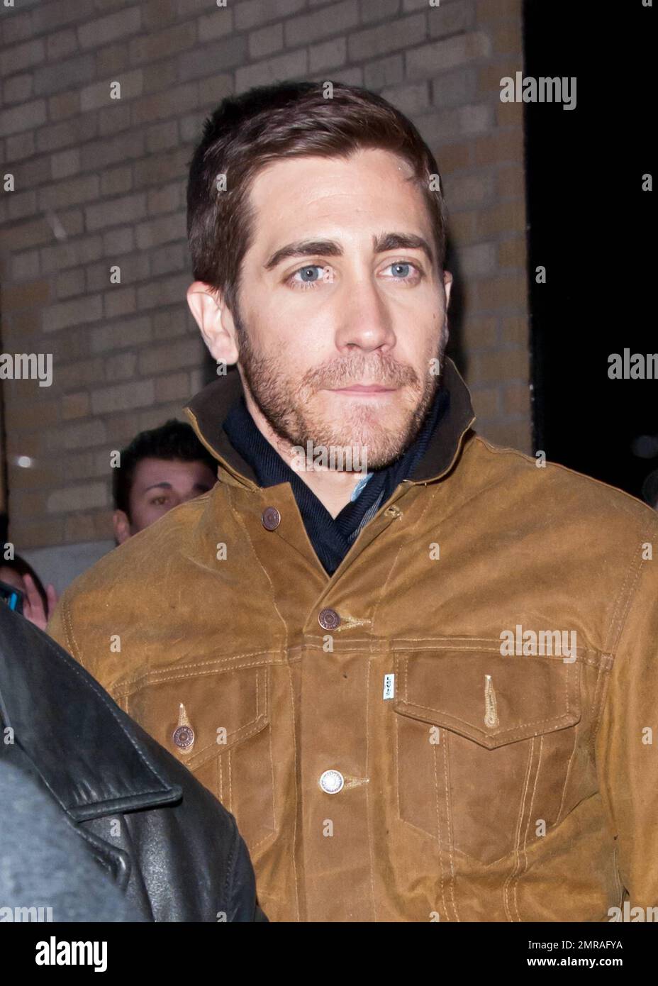 Guided by bodyguards, actor Jake Gyllenhaal arrives at the Apple Store ...
