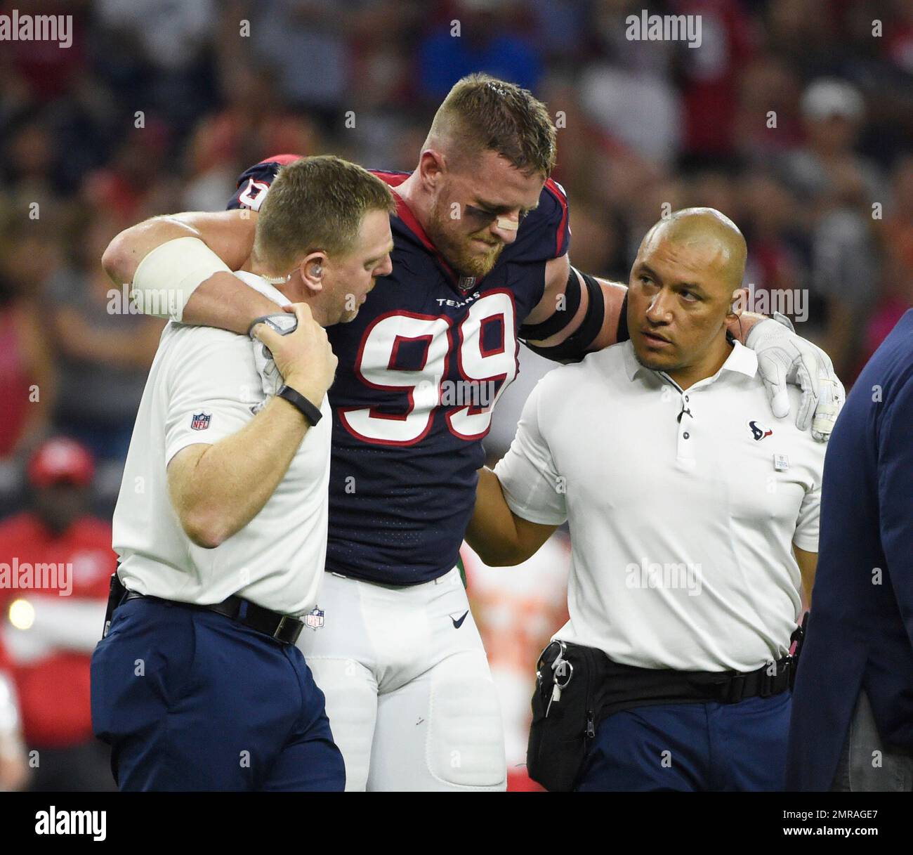 Houston Texans defensive end J.J. Watt (99) is helped off the field ...