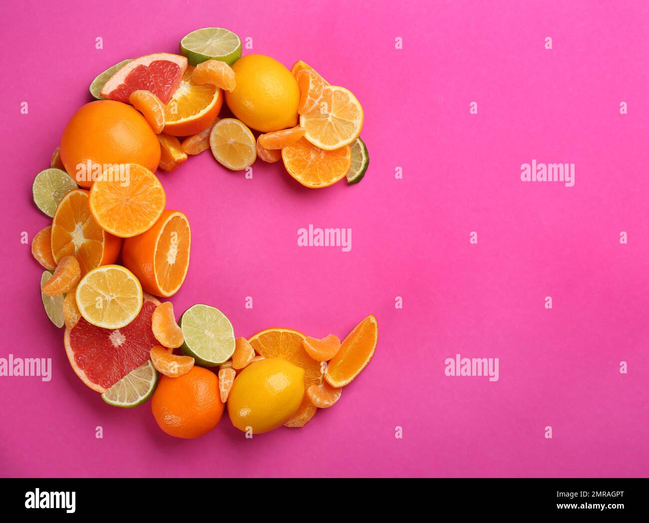 Letter C made with citrus fruits on pink background as vitamin ...