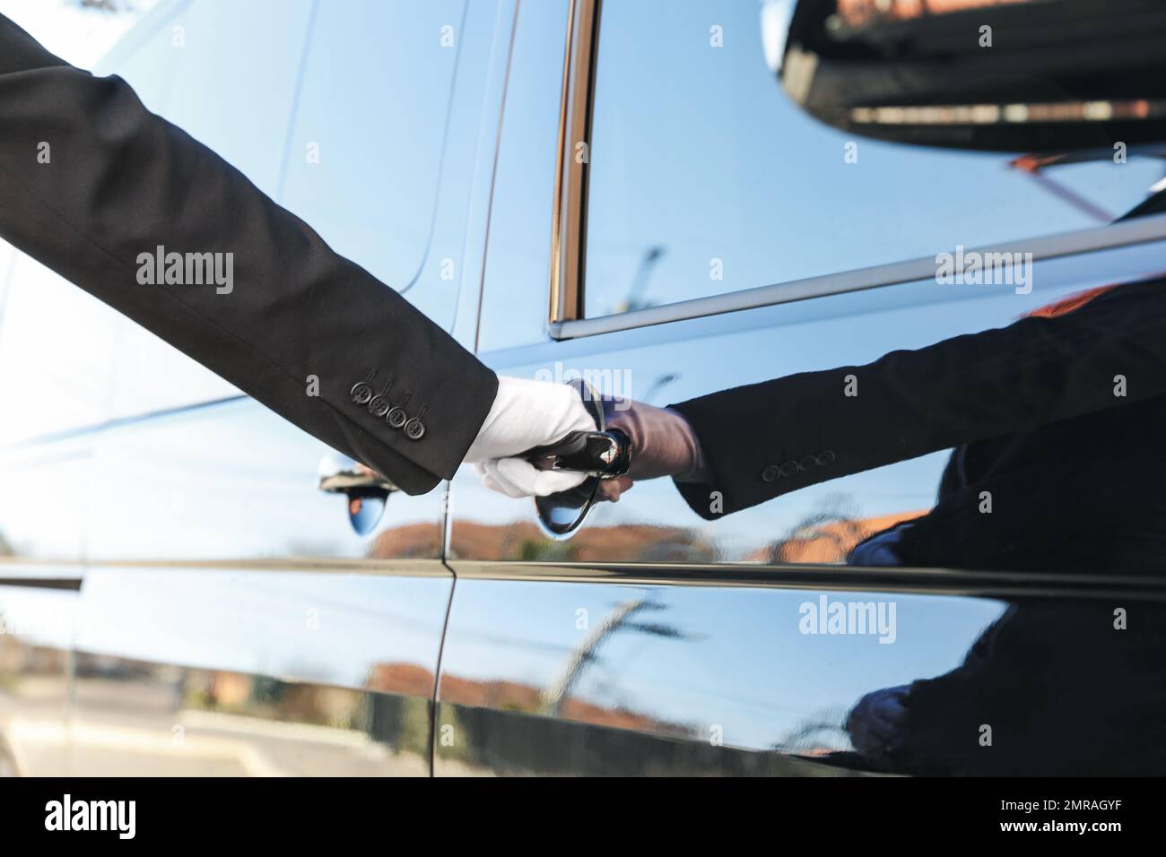 Driver opening door of luxury car, closeup. Chauffeur service Stock ...
