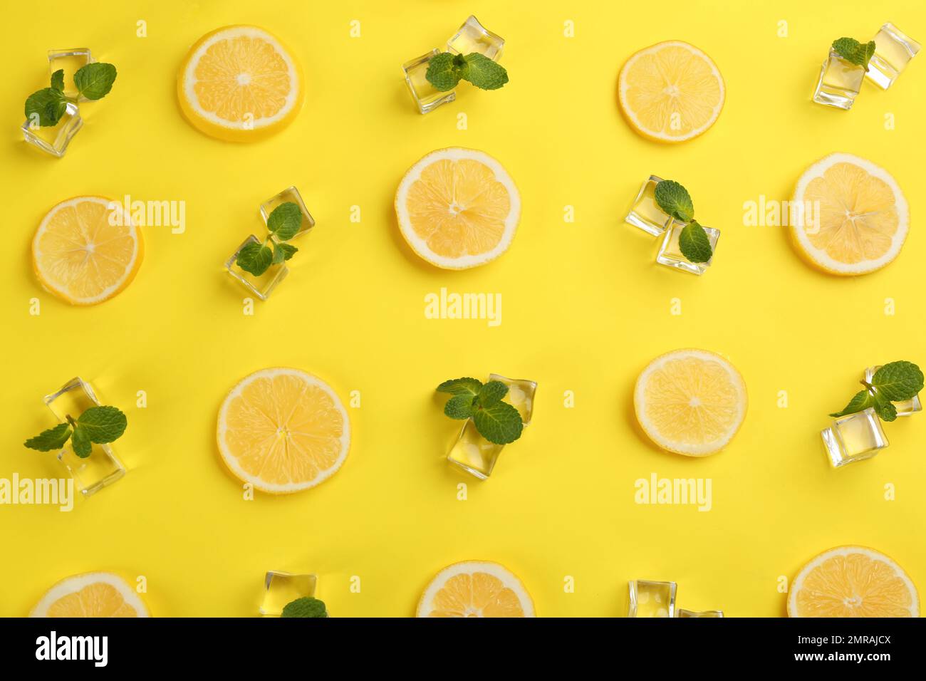 Lemonade layout with juicy lemon slices, ice and mint on yellow ...
