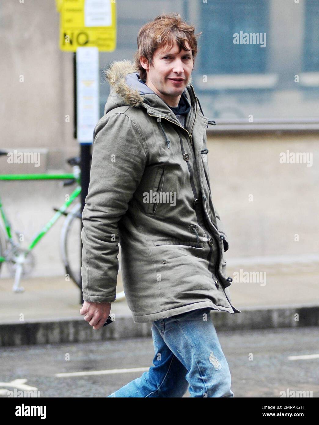 Keeping warm in a parka, singer songwriter James Blunt takes a stroll ...