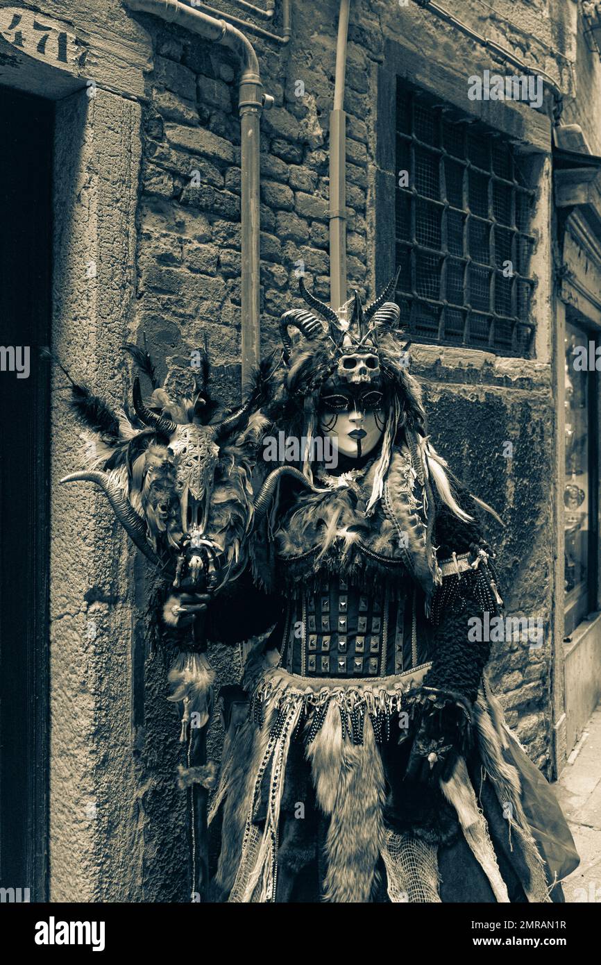 A model dressed in carnival costume of pagan witch with the sculls ...