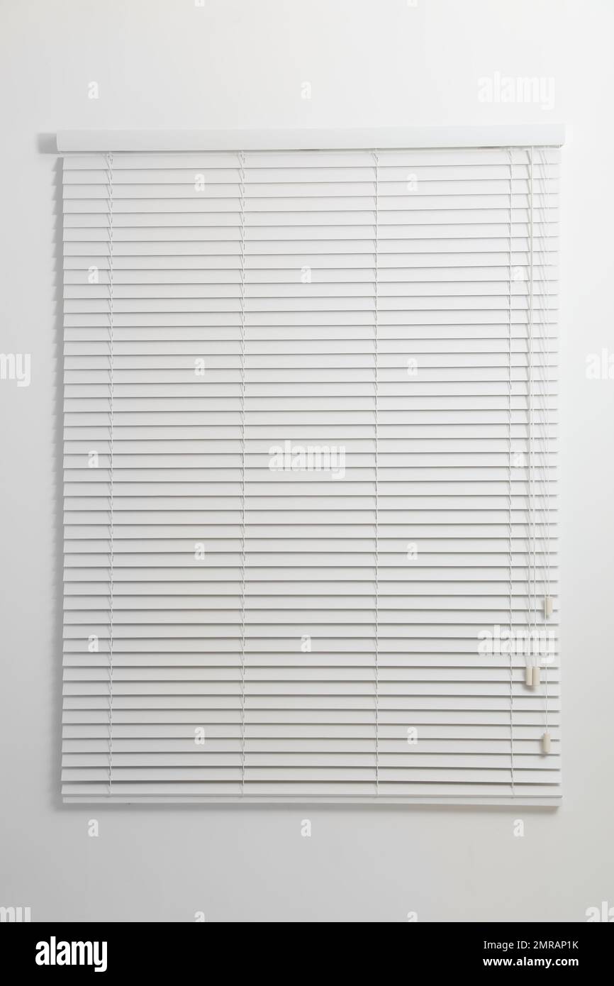 Modern window with closed blinds in room Stock Photo - Alamy