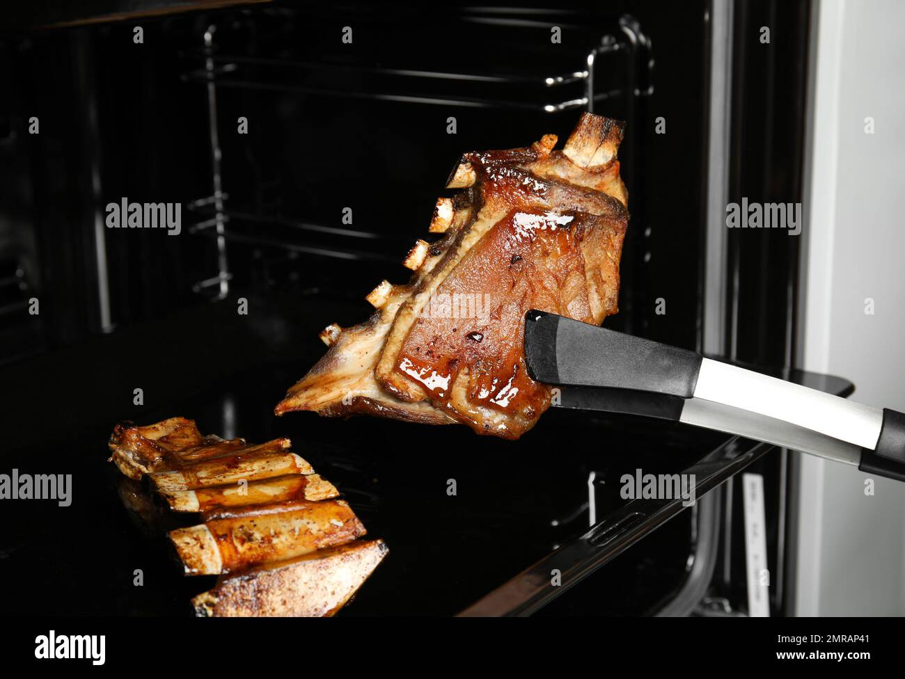 Delicious roasted ribs in oven. Yummy meat Stock Photo - Alamy