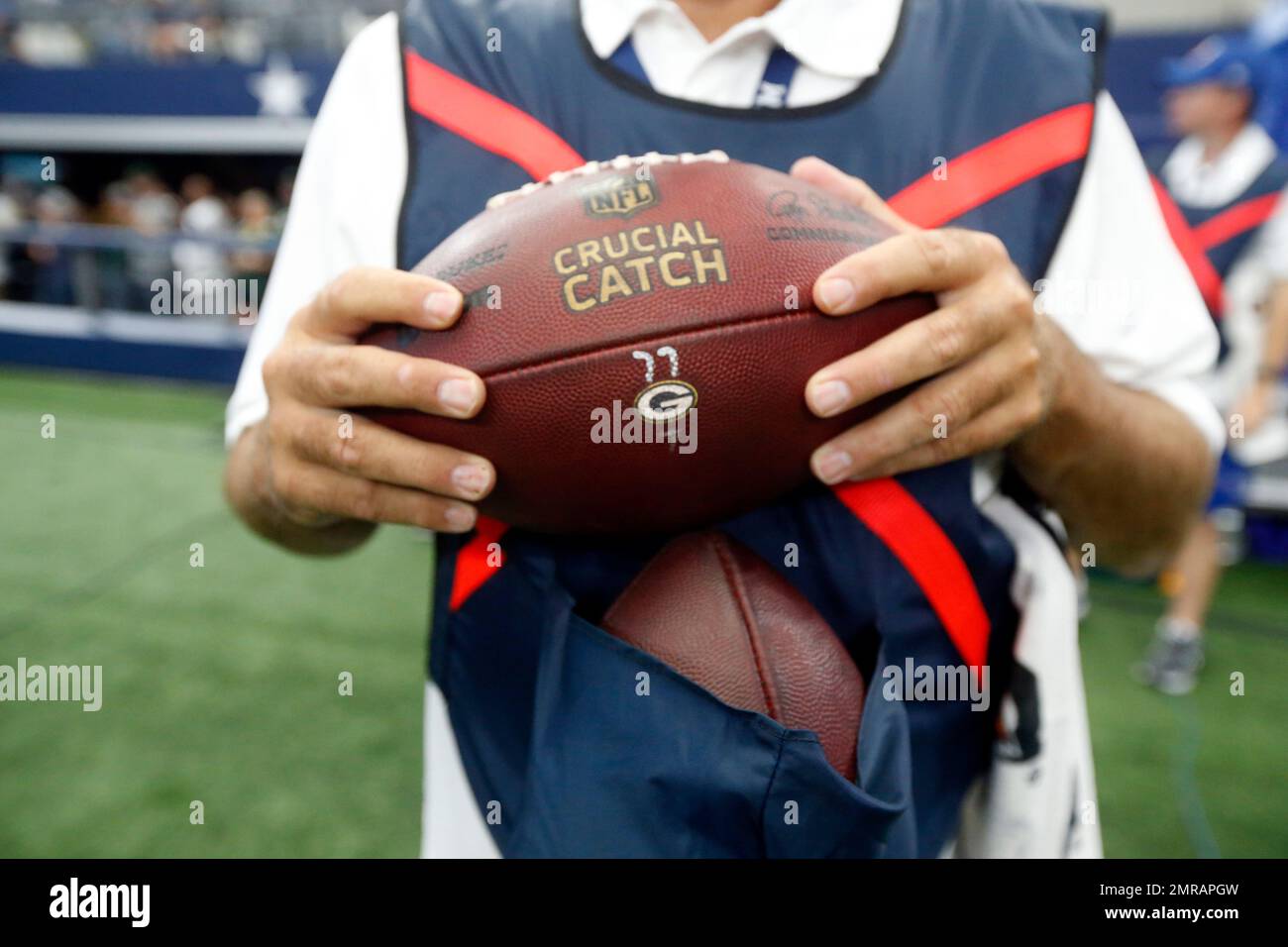 A football with a Crucial Catch Campaign logo on it is shown in the ...