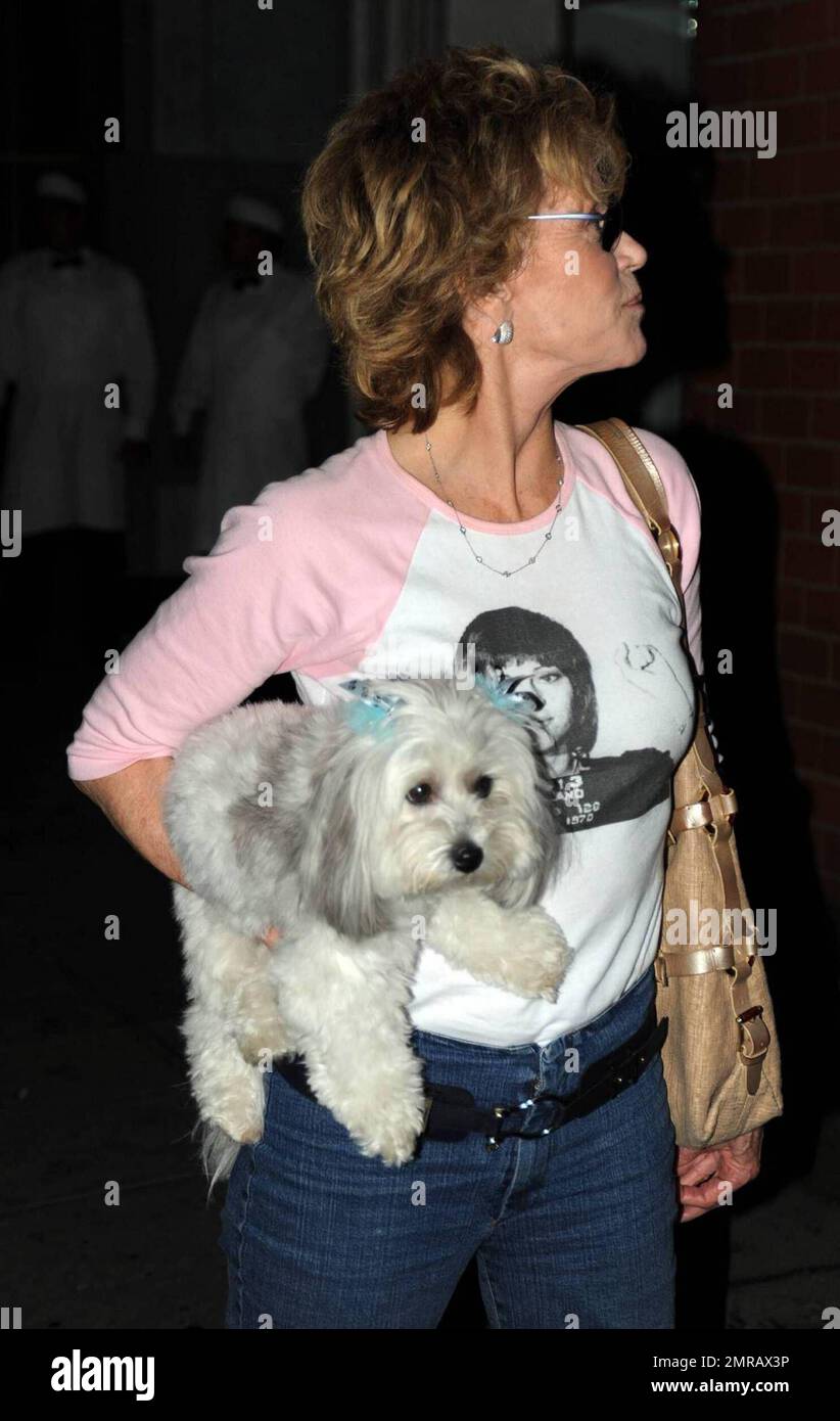 Actress Jane Fonda wears a top with her own mugshot on it and carries ...